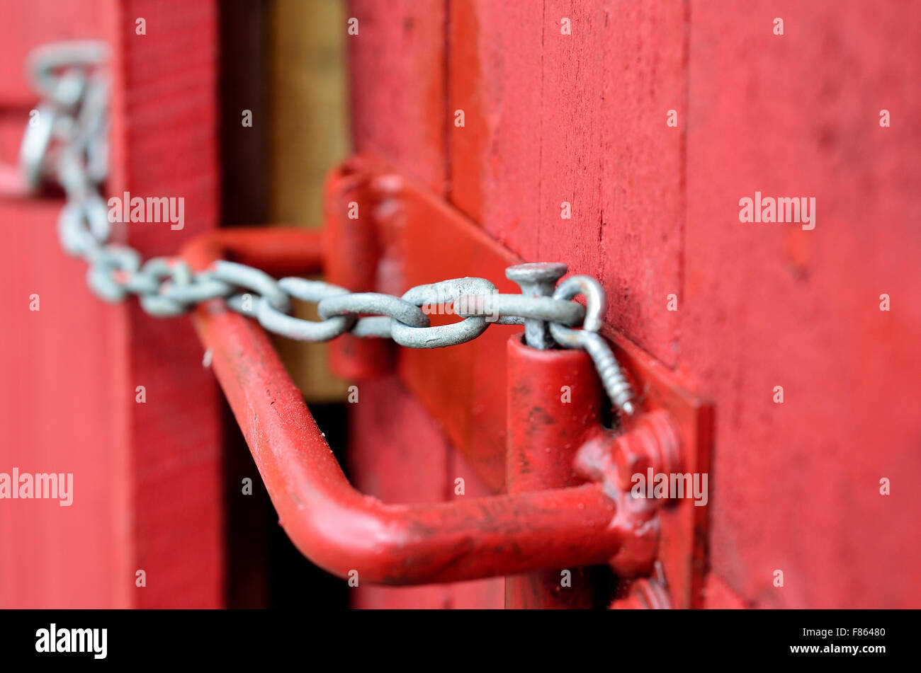 small chain lock on red door Stock Photo - Alamy