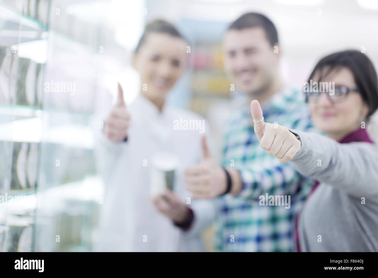 young pharmacist suggesting medical drug to buyer in pharmacy drugstore ...