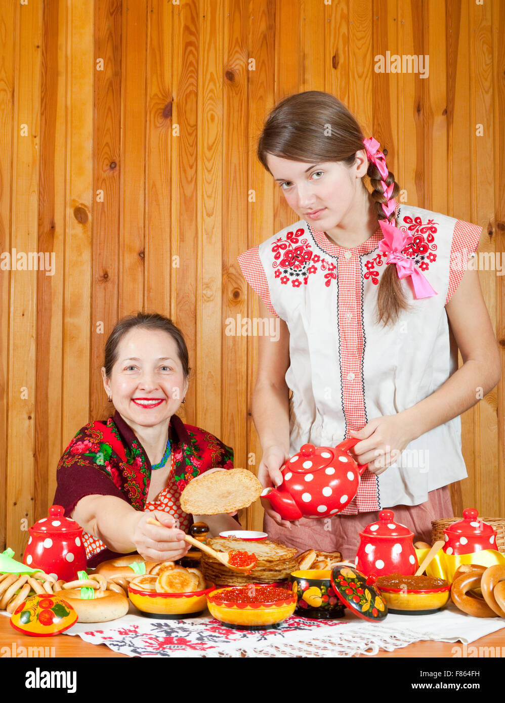 Women in traditional clothes with pancake during Pancake Week Stock ...