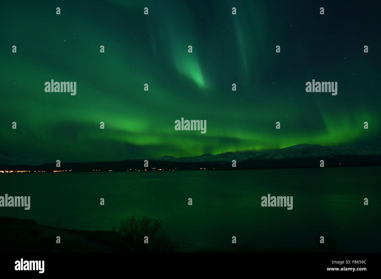 insanly strong aurora borealis over arctic fjord and mountain landscape ...