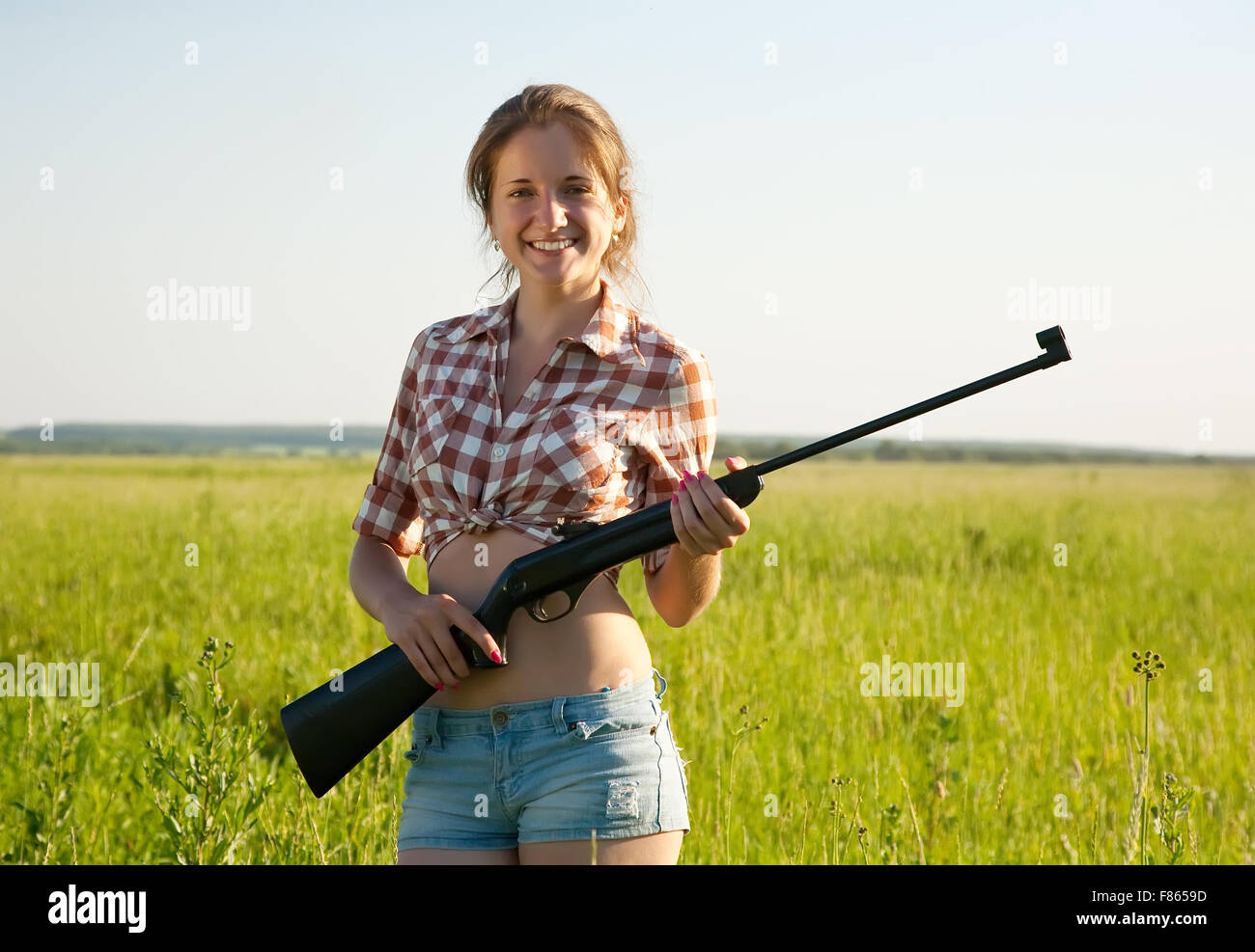 beautiful girl holding pneumatic air rifle outdoor Stock Photo - Alamy