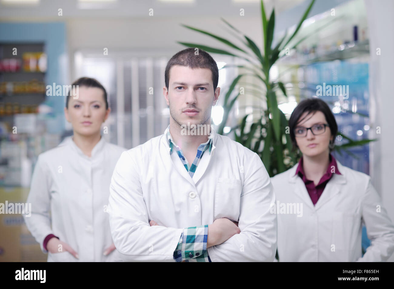 team of pharmacist chemist woman and man group standing in pharmacy ...