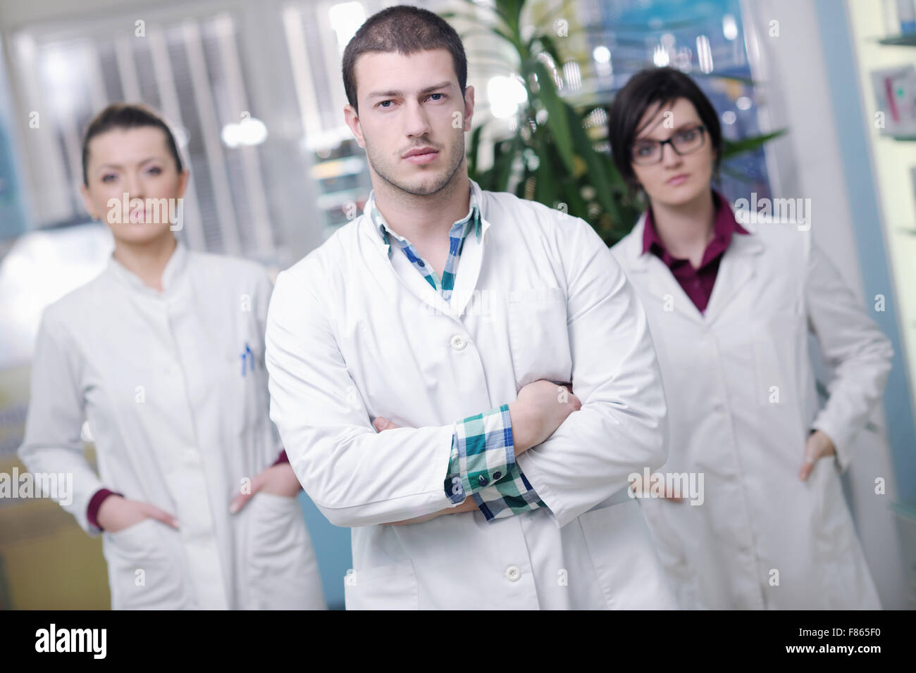 team of pharmacist chemist woman and man group standing in pharmacy ...