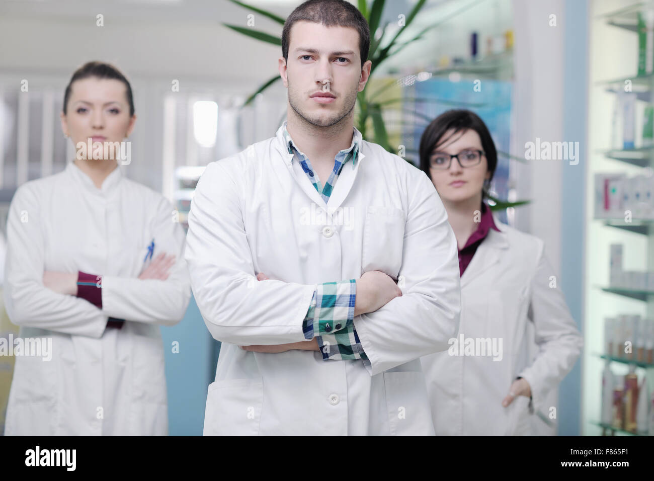 team of pharmacist chemist woman and man group standing in pharmacy ...