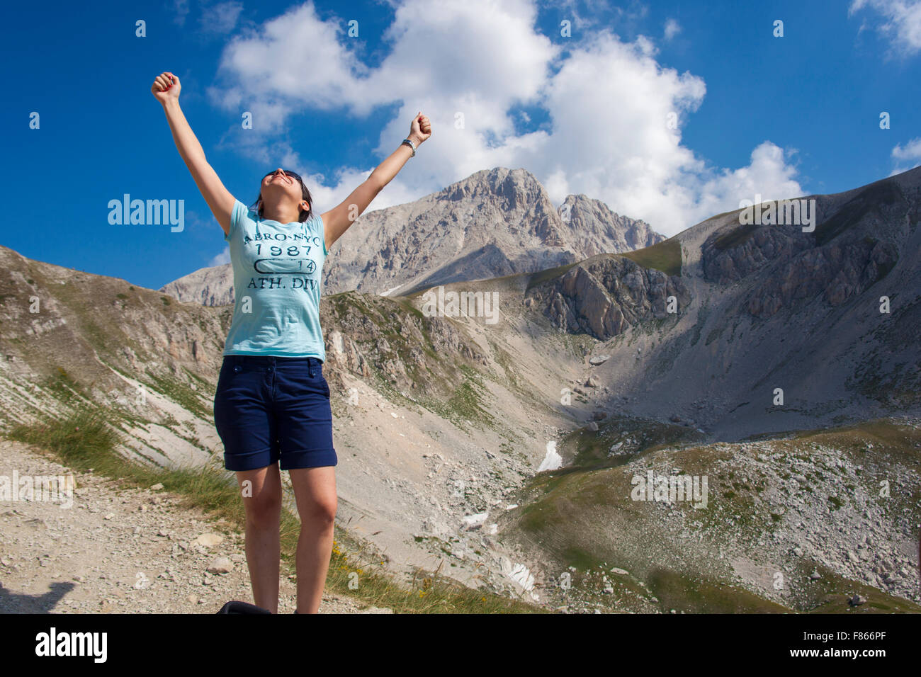 A woman celebrating a successful climb Stock Photo - Alamy