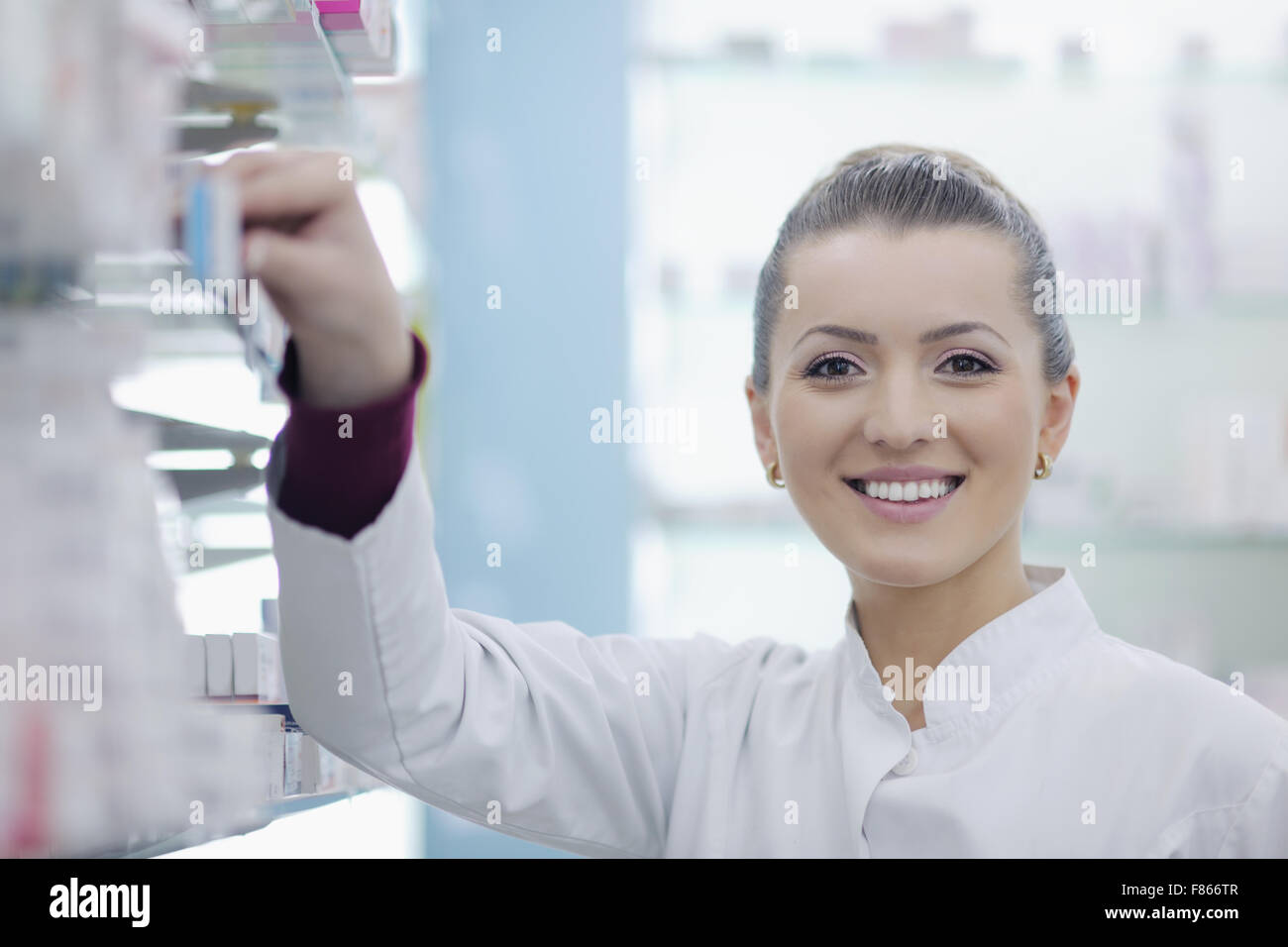 Happy cheerful pharmacist chemist woman standing in pharmacy drugstore ...