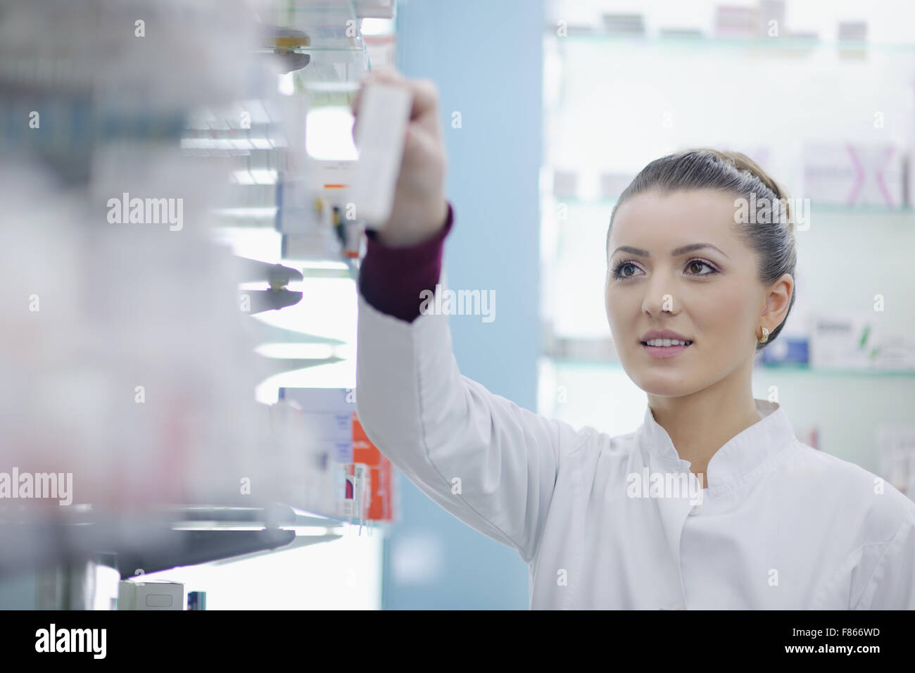 Happy cheerful pharmacist chemist woman standing in pharmacy drugstore ...