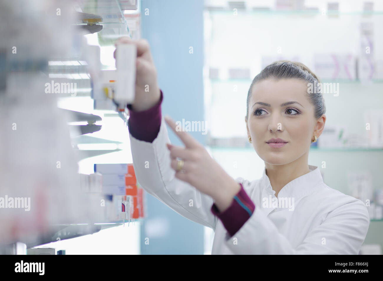 Happy cheerful pharmacist chemist woman standing in pharmacy drugstore ...