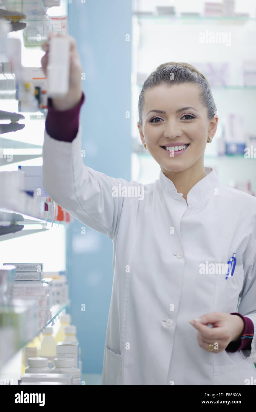 Happy cheerful pharmacist chemist woman standing in pharmacy drugstore ...