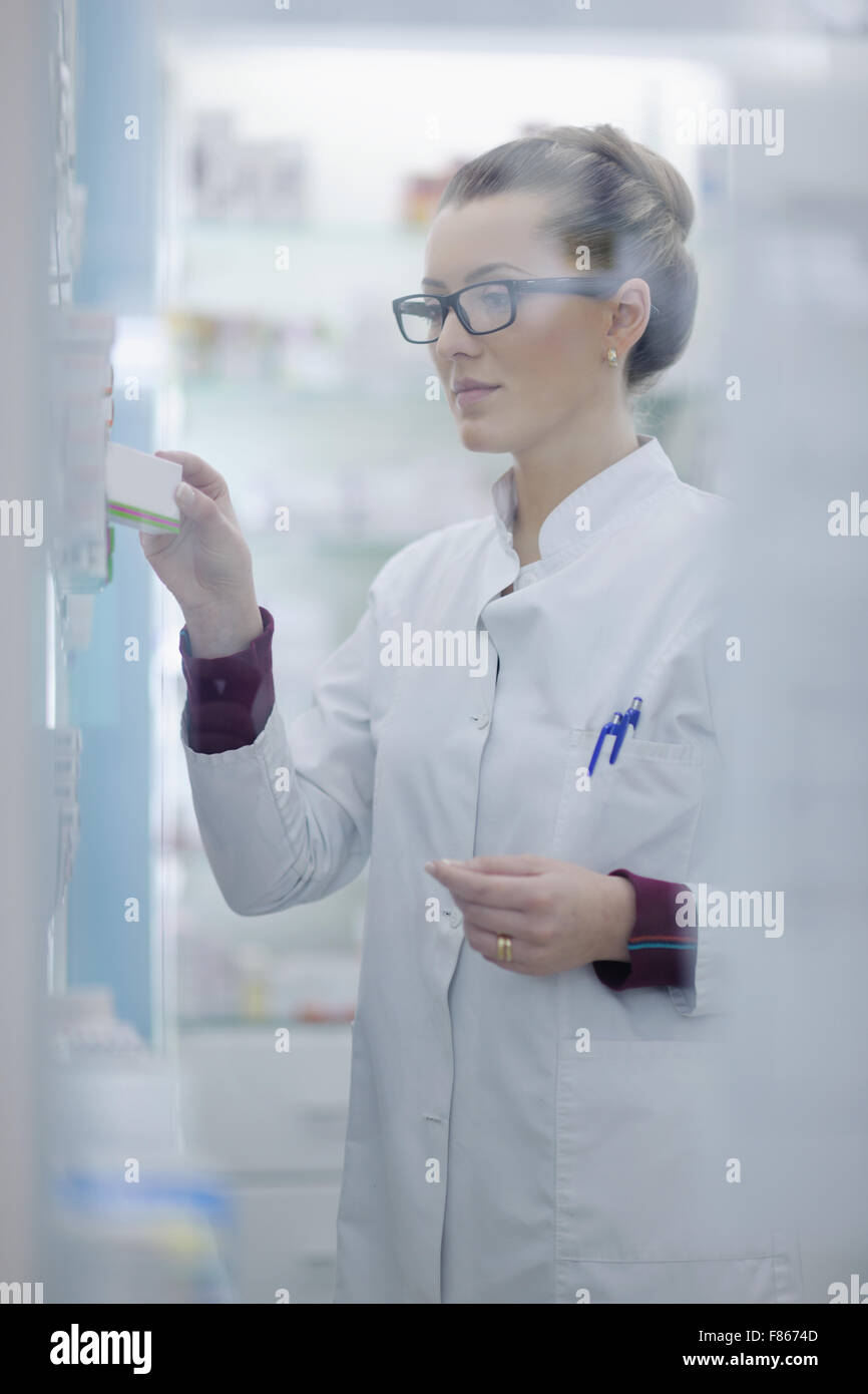 Happy cheerful pharmacist chemist woman standing in pharmacy drugstore ...