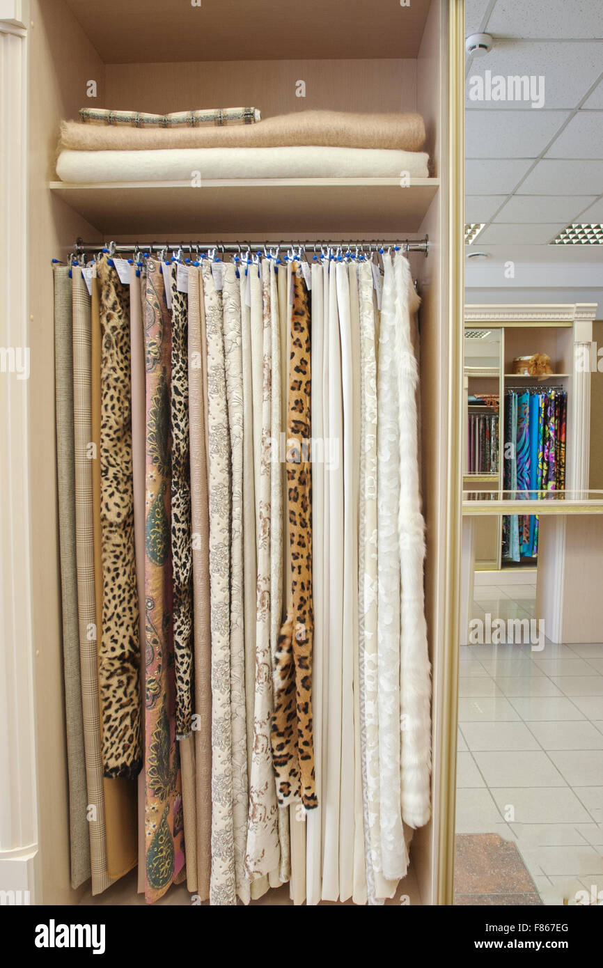 Colorful fabric samples hanging from hangers Stock Photo - Alamy