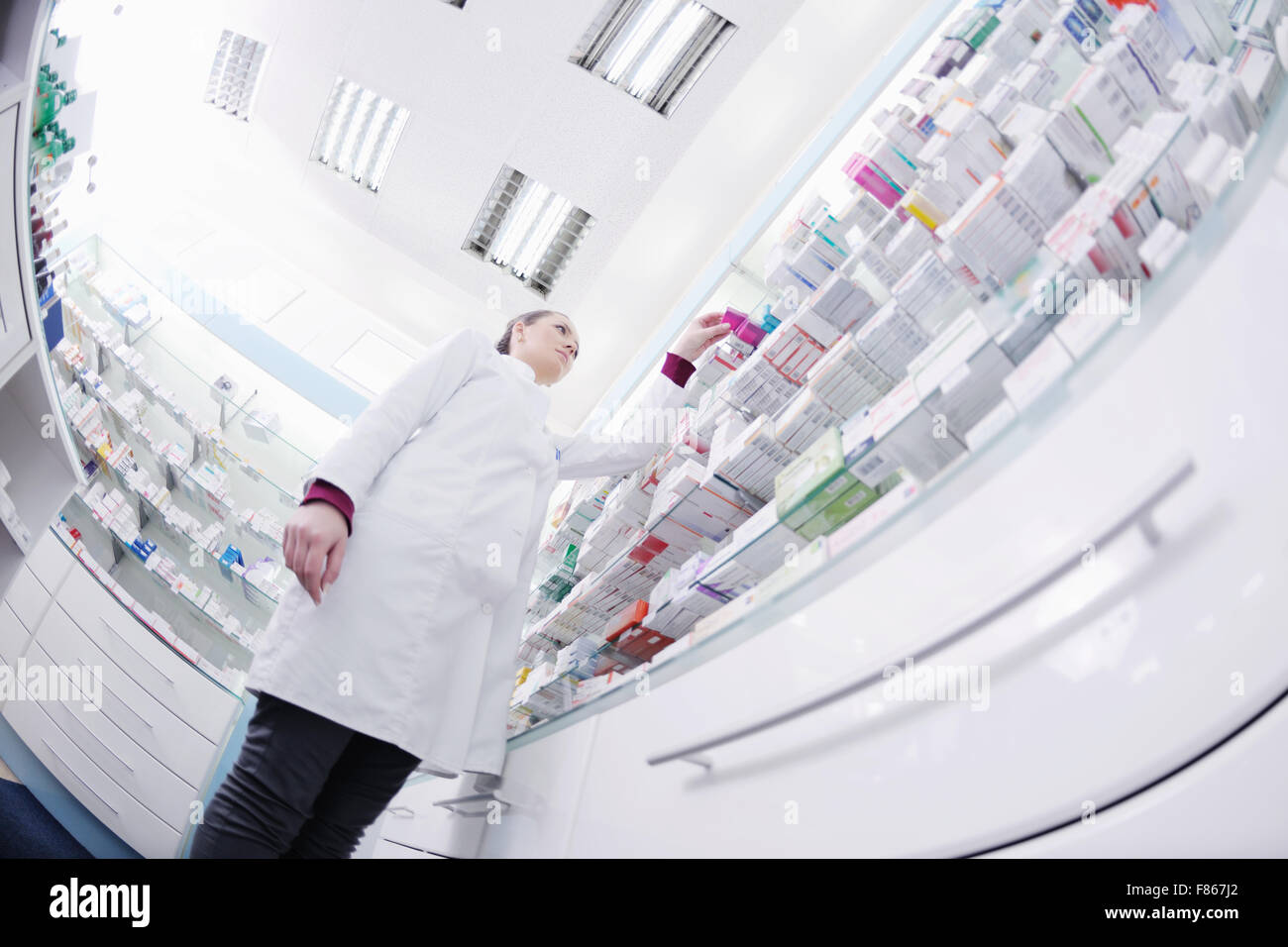 Happy cheerful pharmacist chemist woman standing in pharmacy drugstore ...