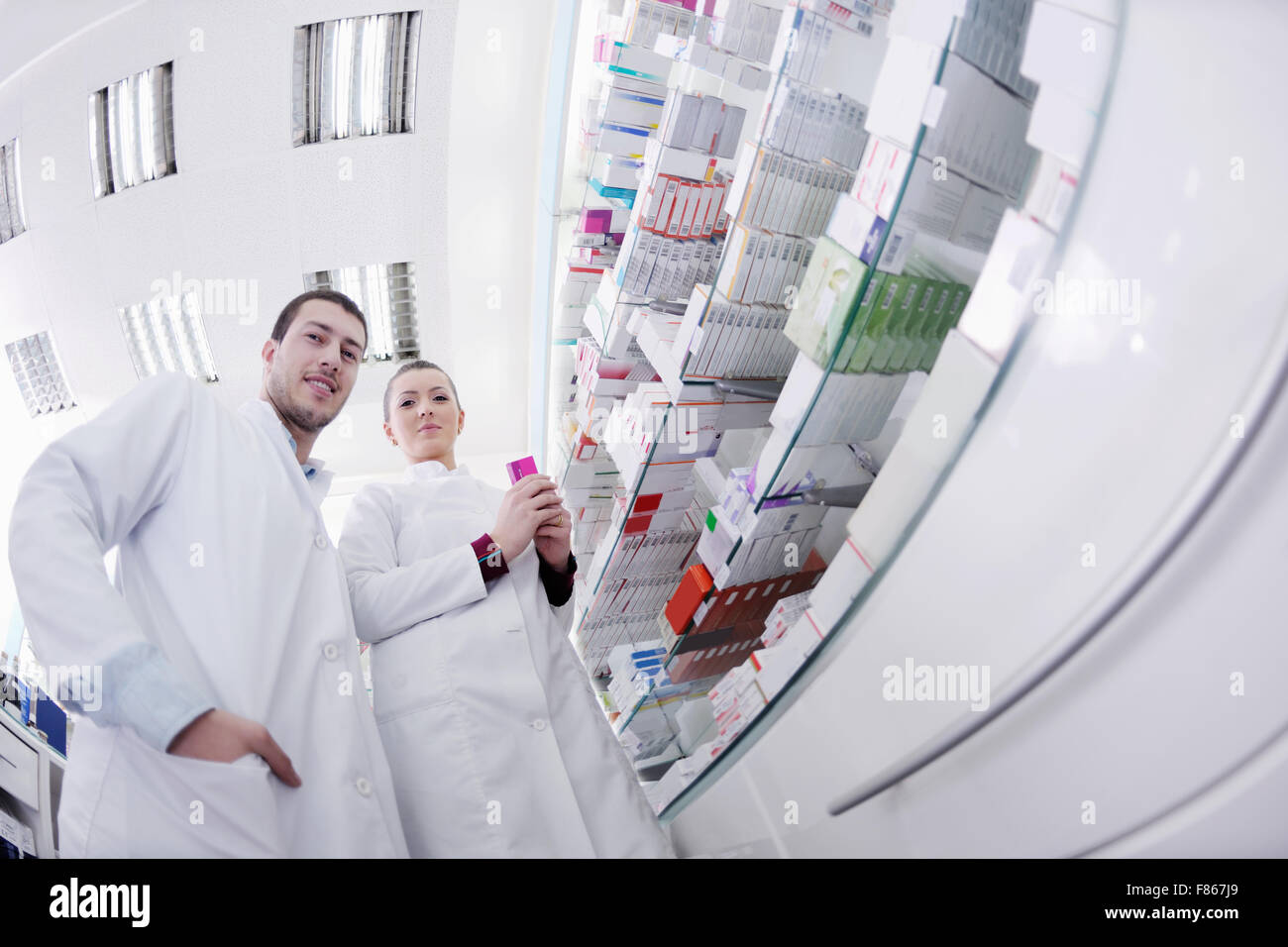 team of pharmacist chemist woman and man group standing in pharmacy ...