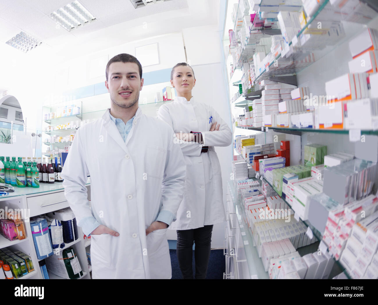 team of pharmacist chemist woman and man group standing in pharmacy ...