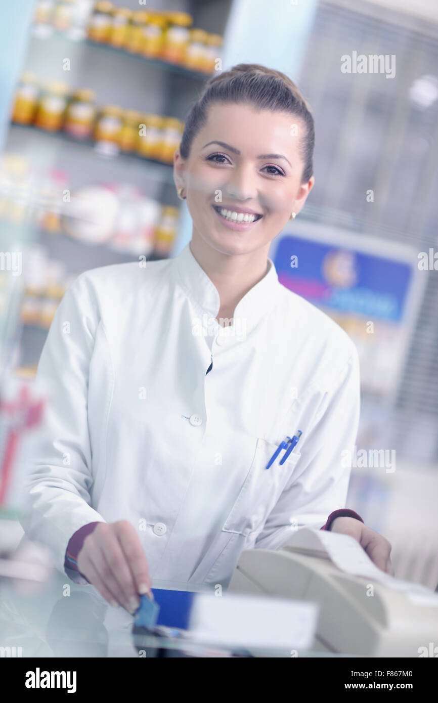 Happy cheerful pharmacist chemist woman standing in pharmacy drugstore ...