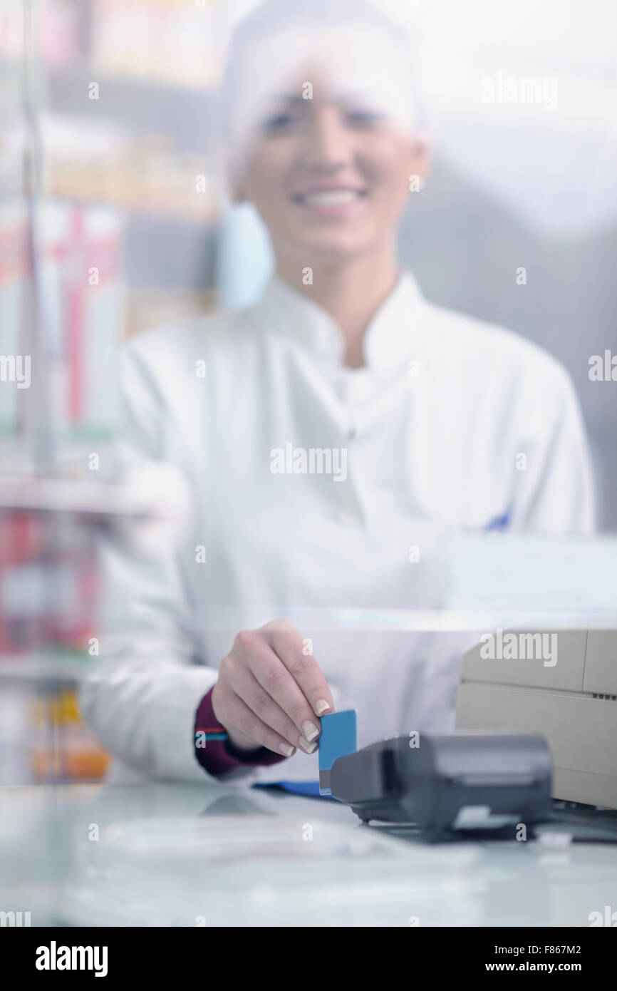 Happy cheerful pharmacist chemist woman standing in pharmacy drugstore ...