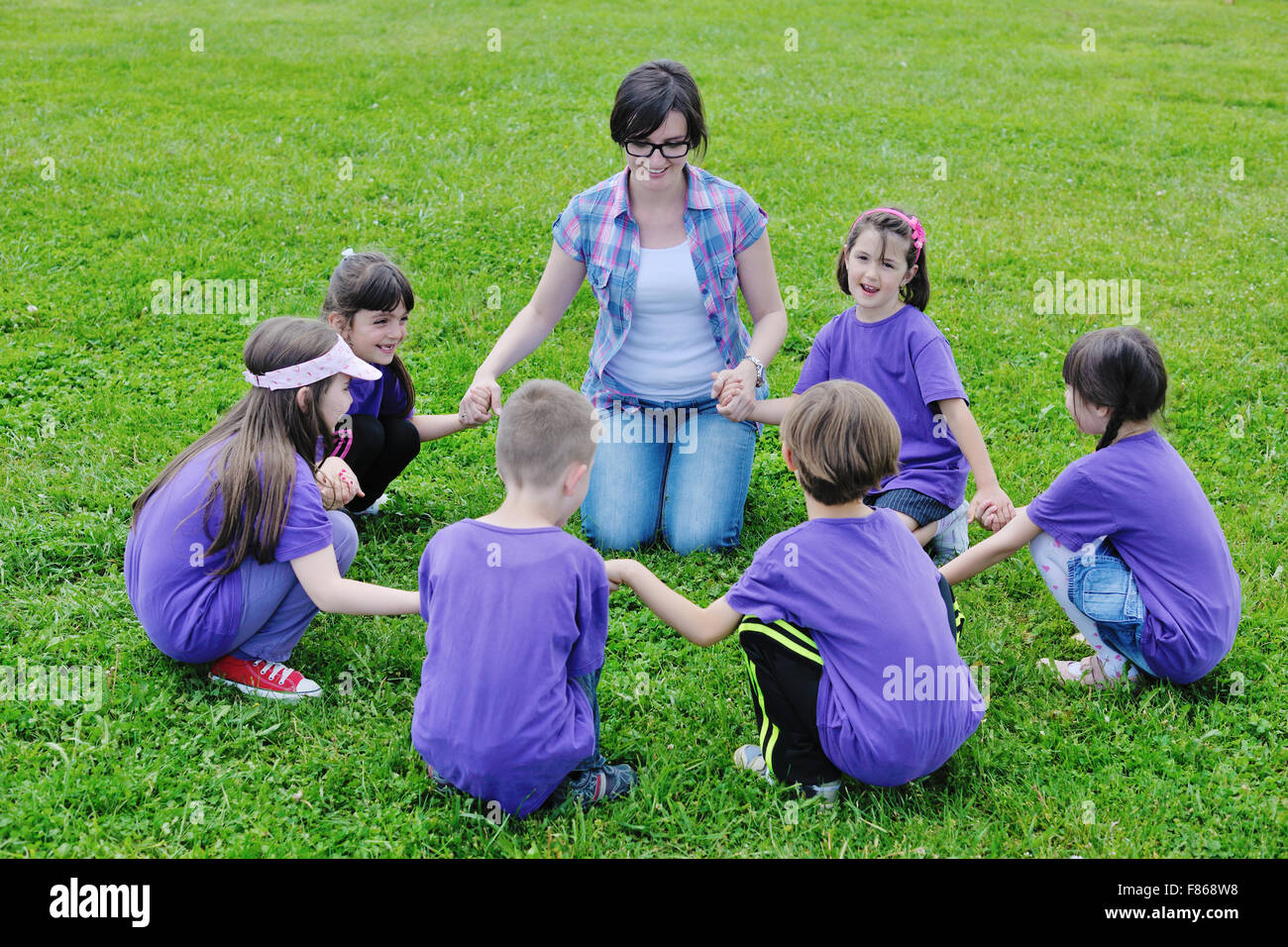 happy preschool kids group have fun and play game on outdoor classes in ...