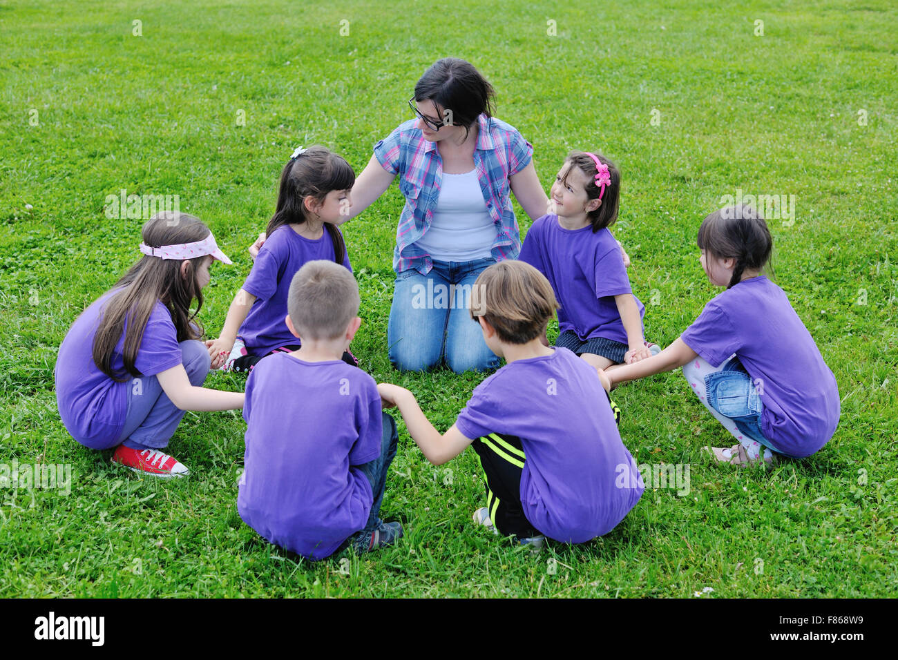happy preschool kids group have fun and play game on outdoor classes in ...