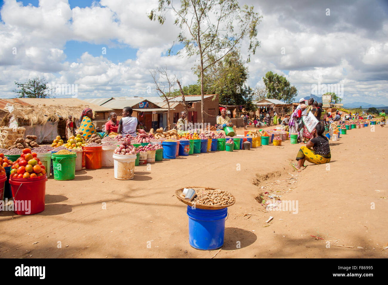 Women and men standing by the roadside selling their produce Stock ...