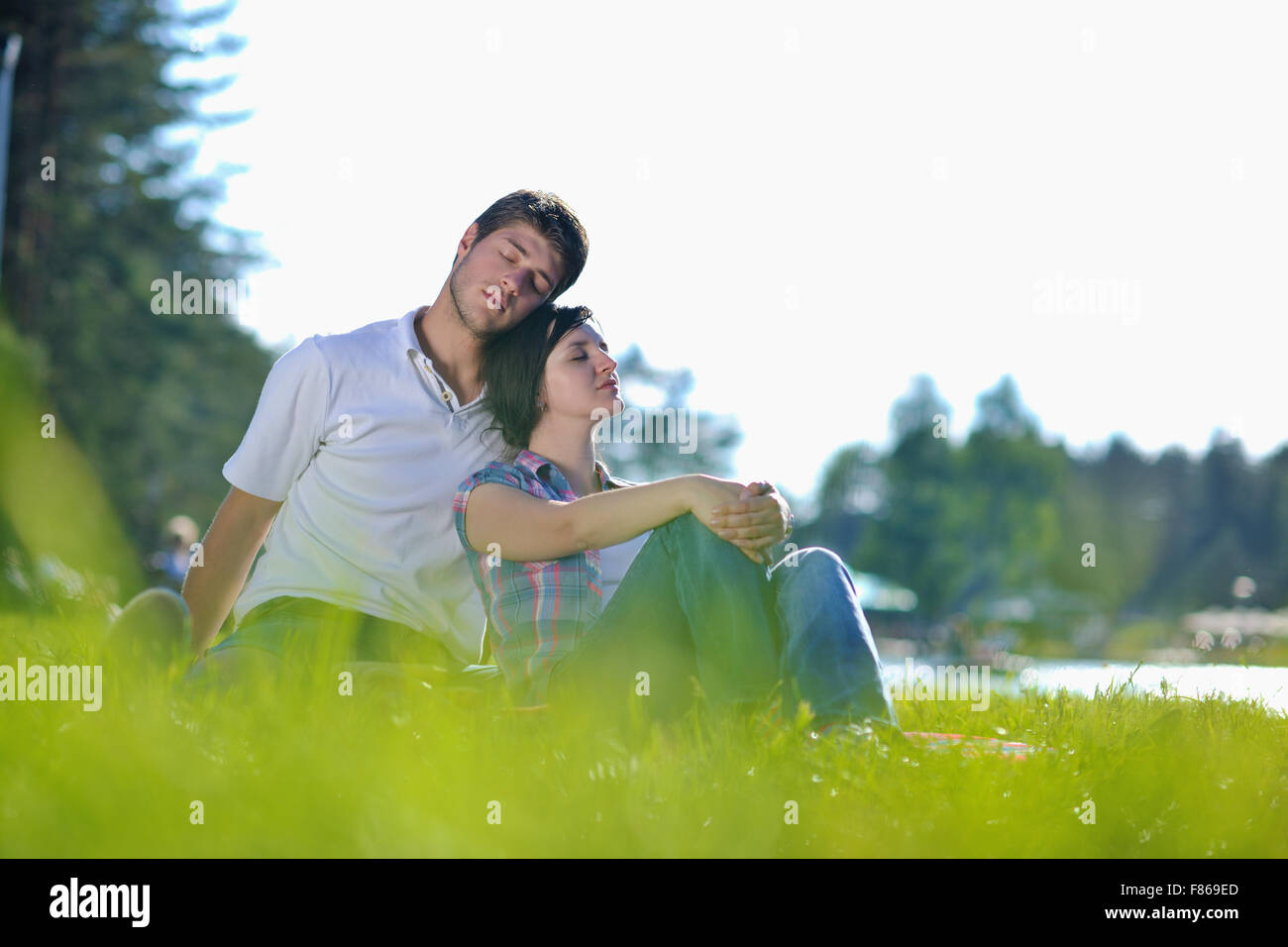 happy young romantic couple in love having a picnic outdoor on a summer ...