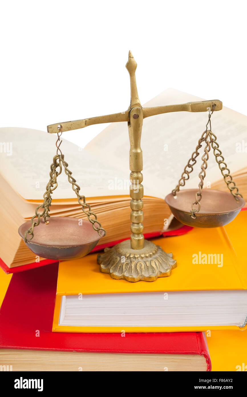 Scales of justice atop legal books over white Stock Photo - Alamy