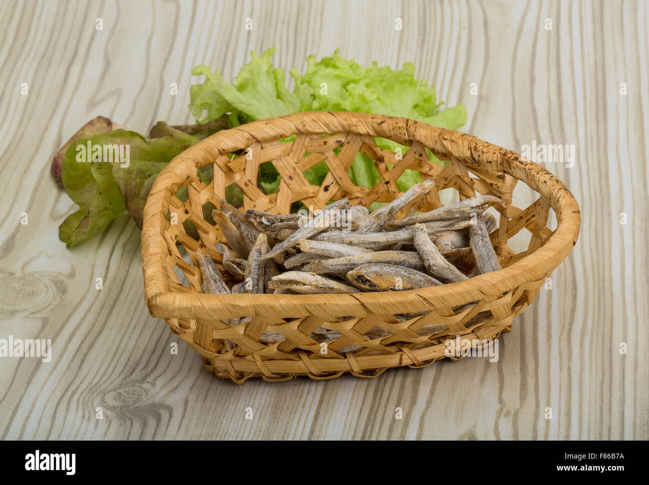 Dries anchovy - small fishes in the bowl Stock Photo - Alamy