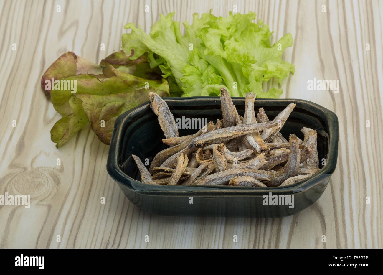 Dries anchovy - small fishes in the bowl Stock Photo - Alamy