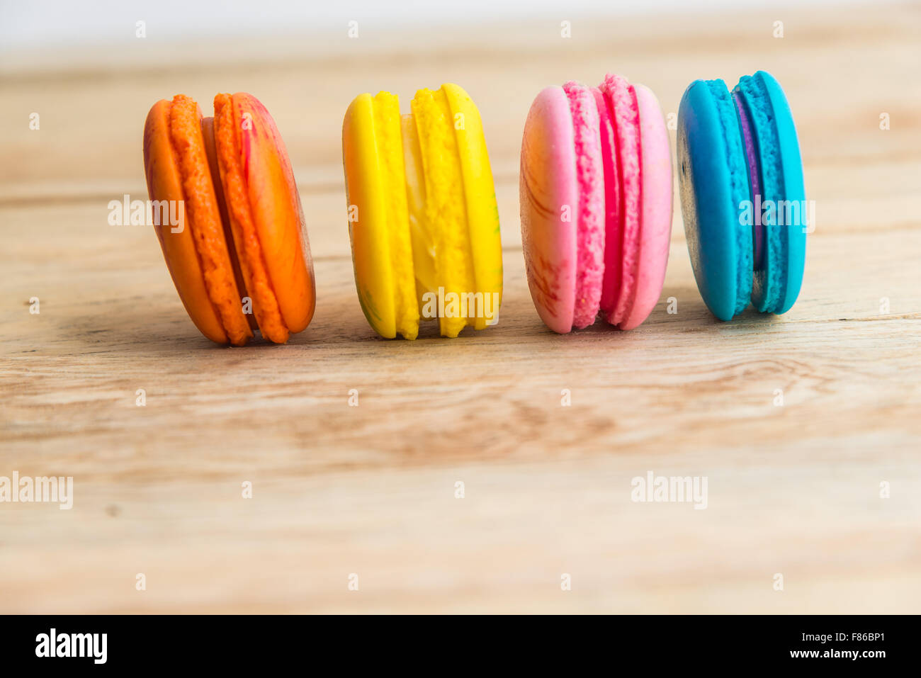 Colorful macaron on wooden floor 2 Stock Photo - Alamy