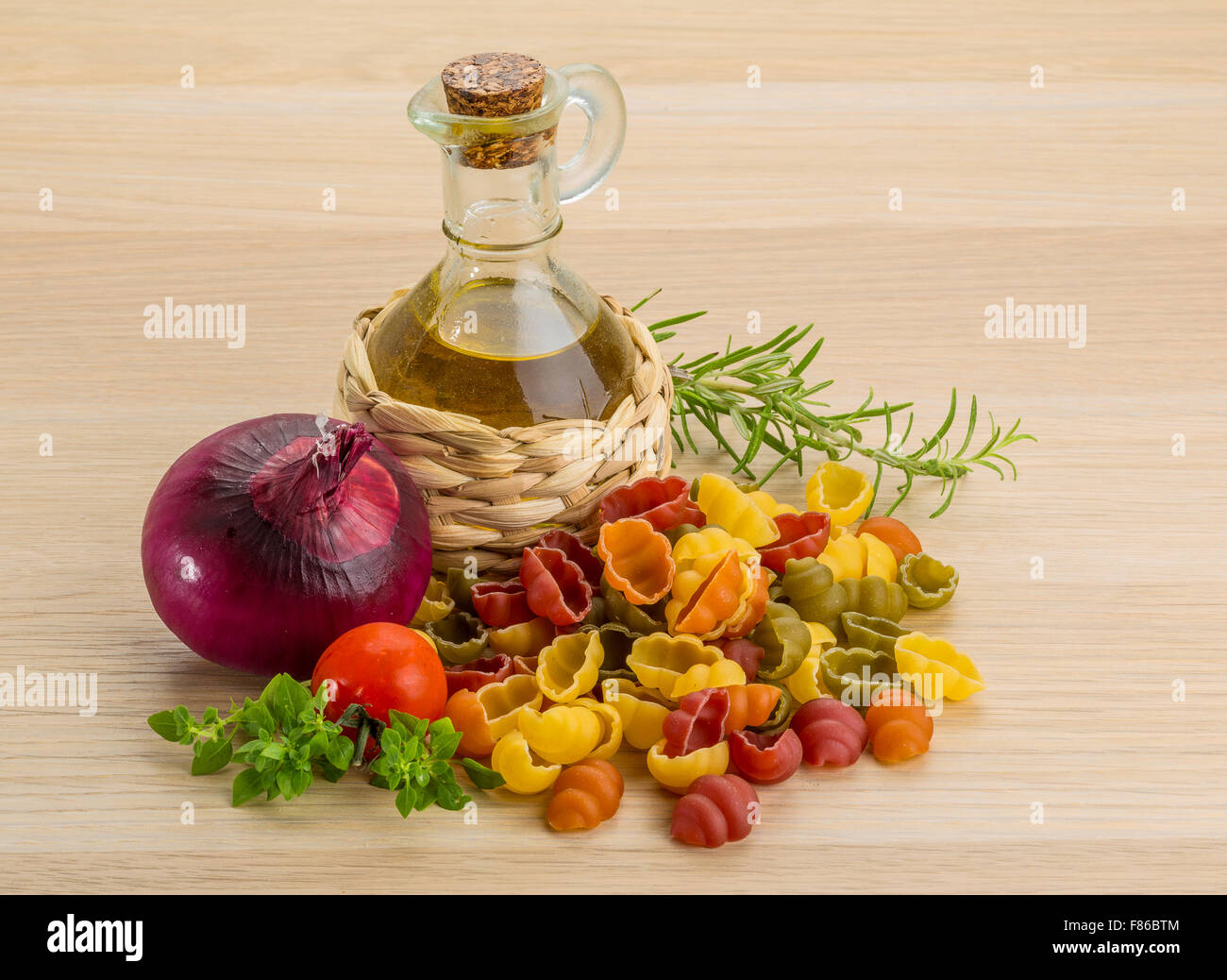 Raw macaroni - shell pasta with herbs Stock Photo - Alamy