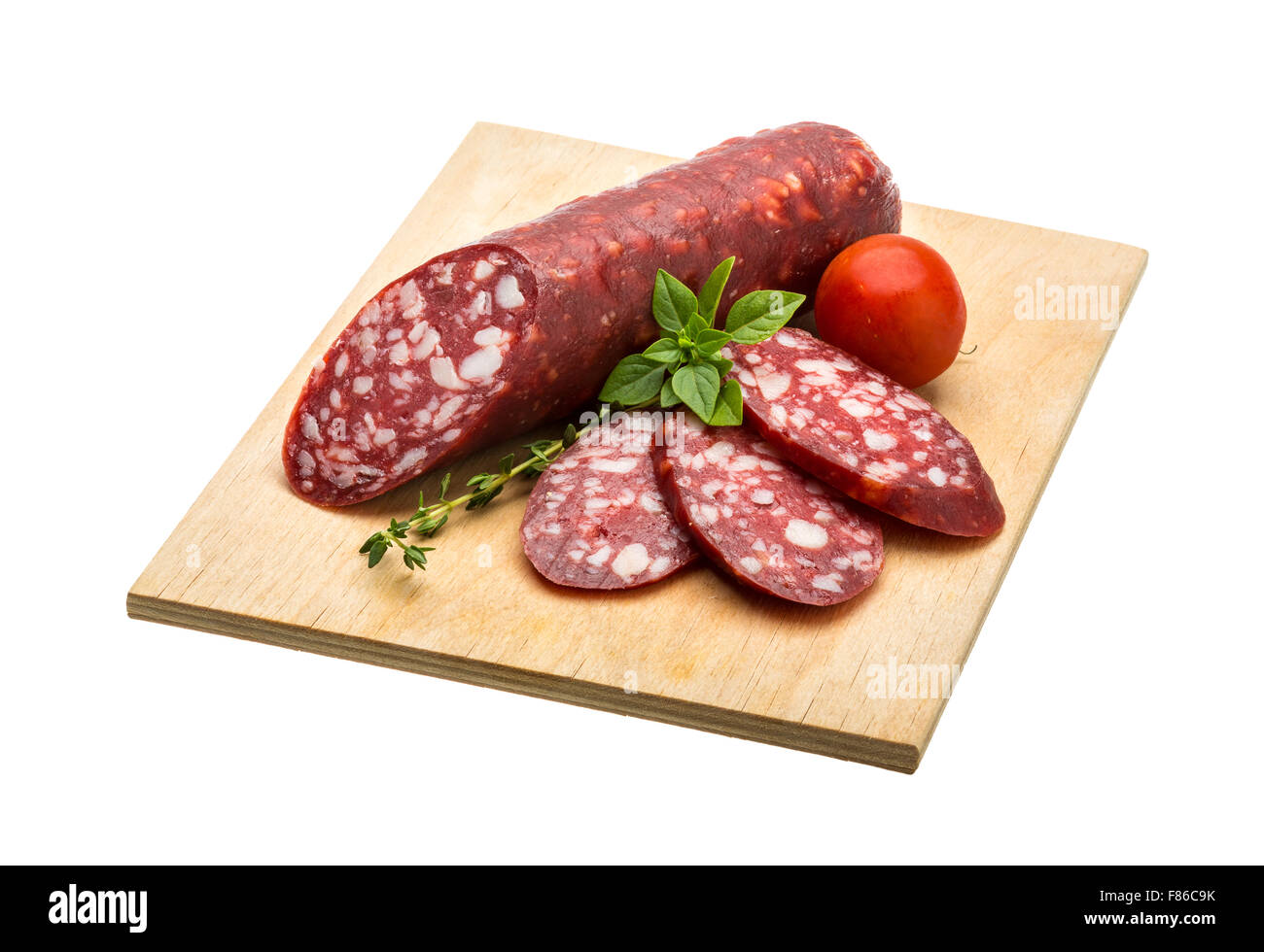Salami sausages sliced with basil and tomato Stock Photo - Alamy