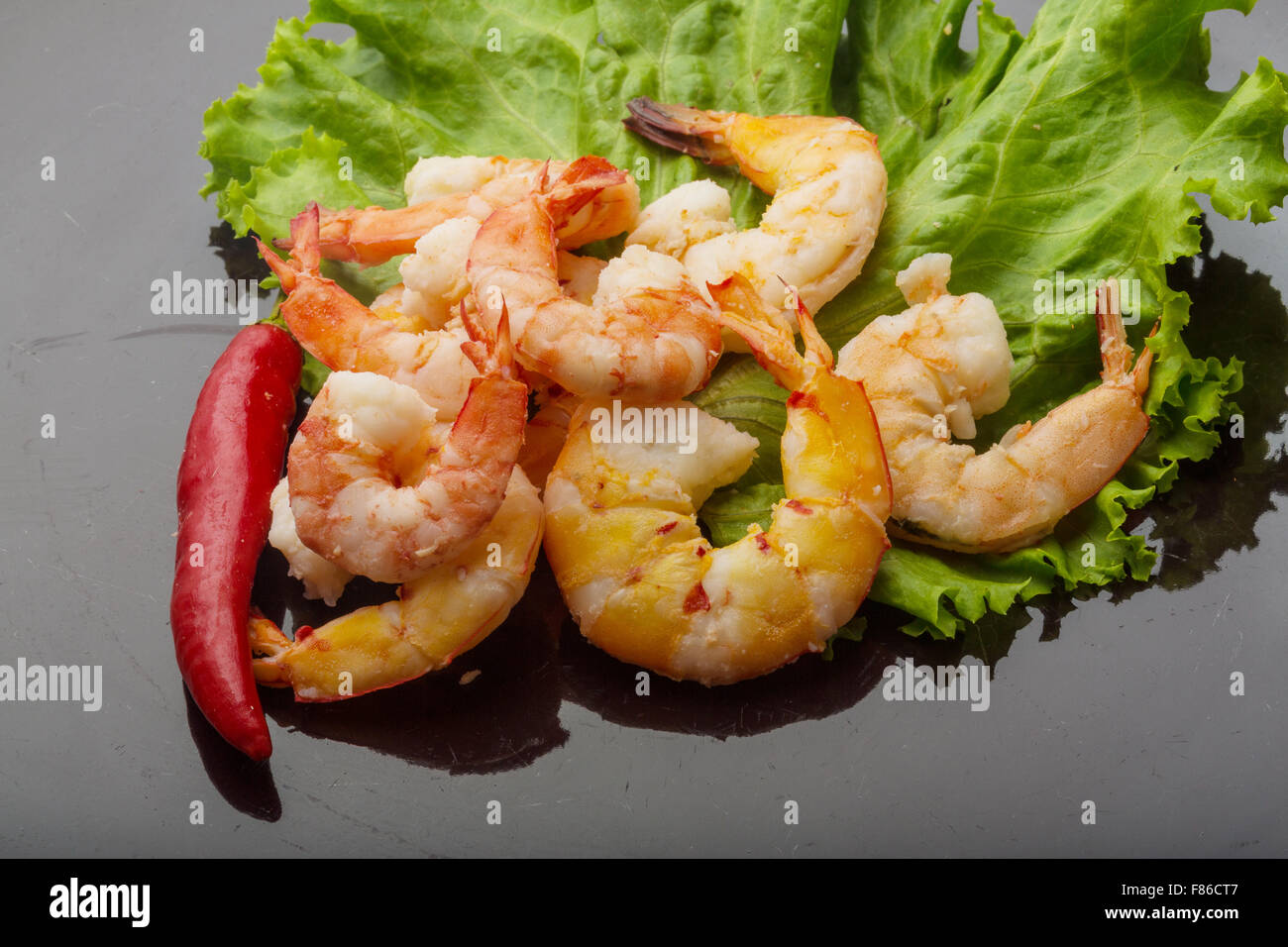 Unshelled king prawn heap with salad leaves Stock Photo - Alamy