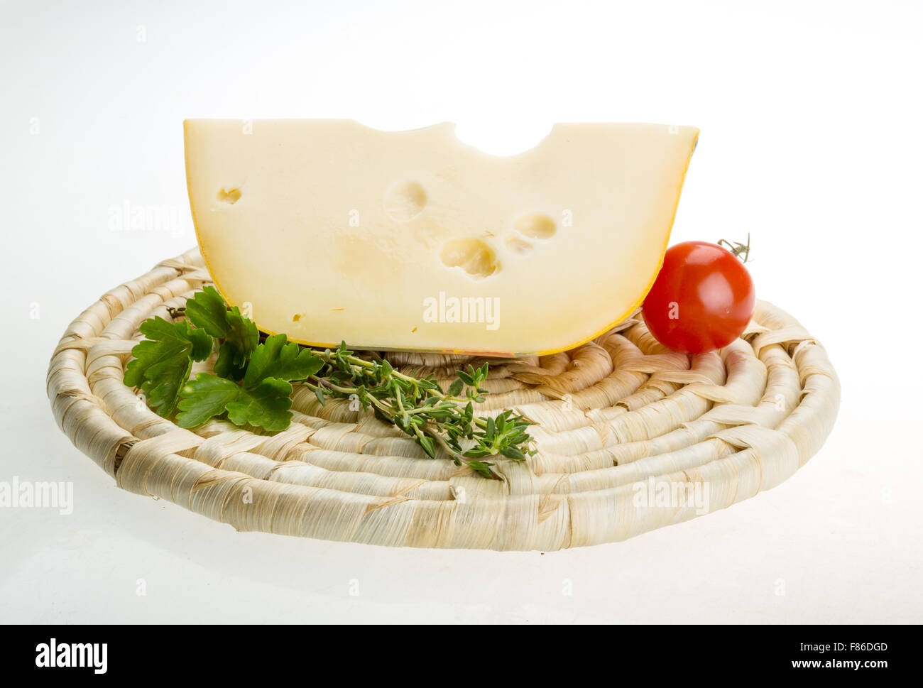 Maasdam cheese with thyme and tomato Stock Photo - Alamy