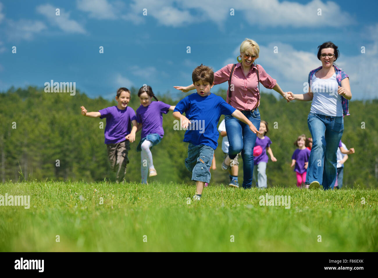 happy kids group have fun in nature outdoors park Stock Photo - Alamy