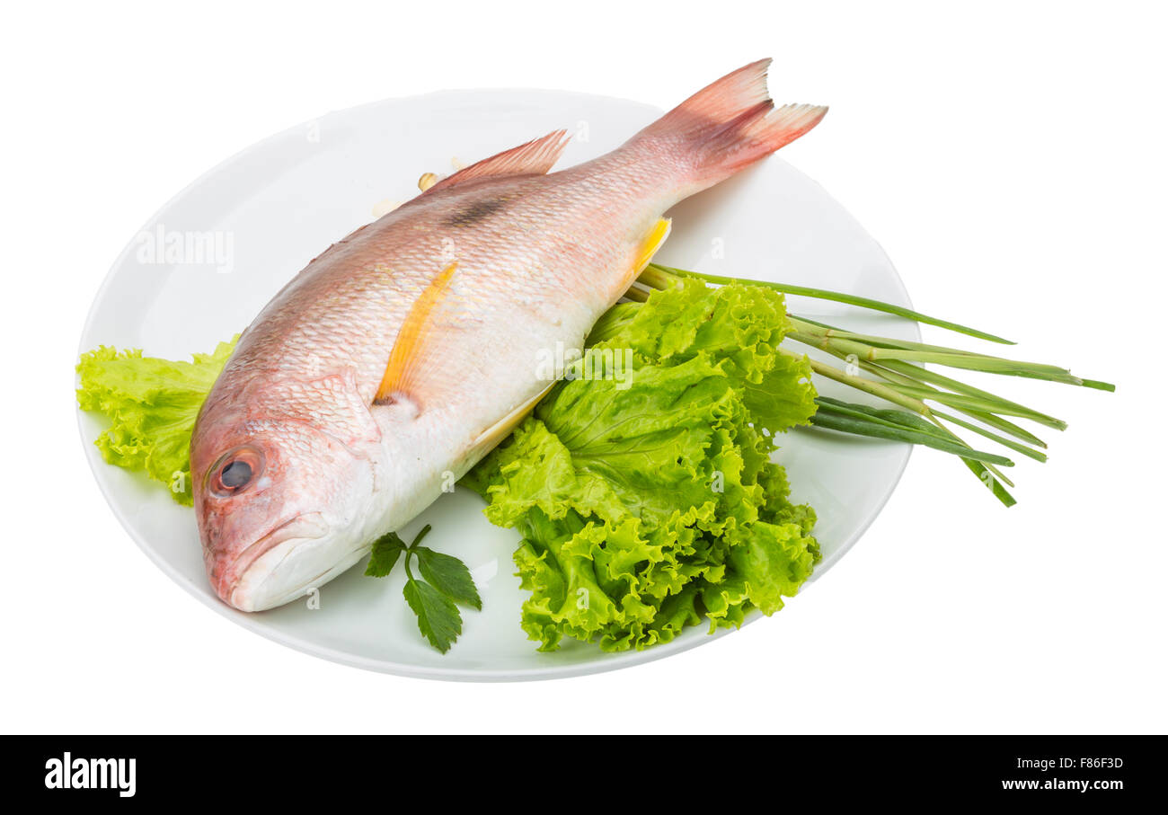Raw red snapper with salad leaves Stock Photo - Alamy
