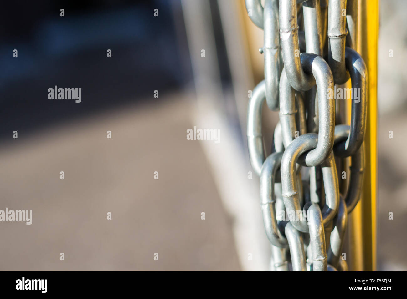 Metal chain link hanging on a post with empty copy-space and metallic ...