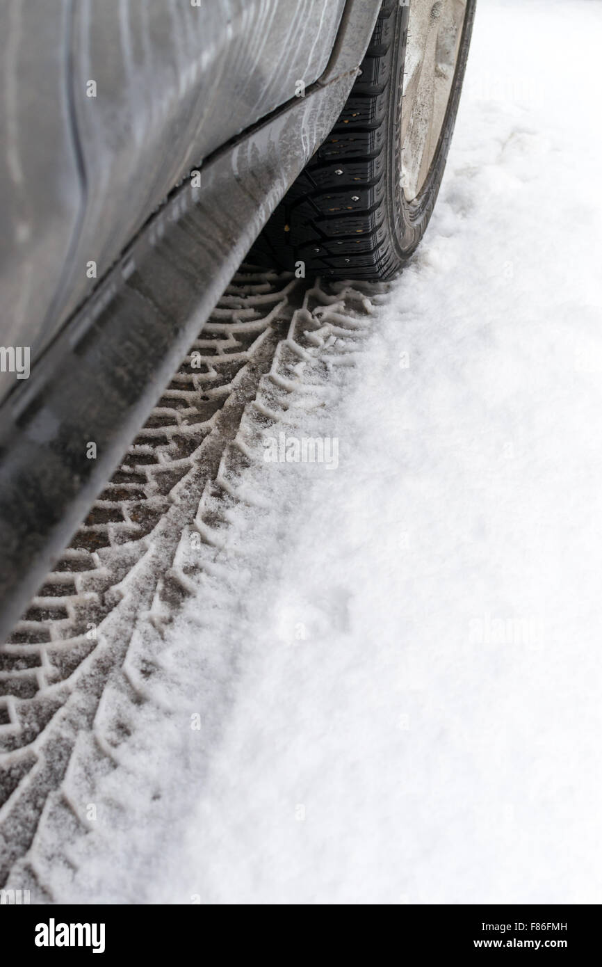 Parked car creates snow tire prints in the wintery chill of the first ...