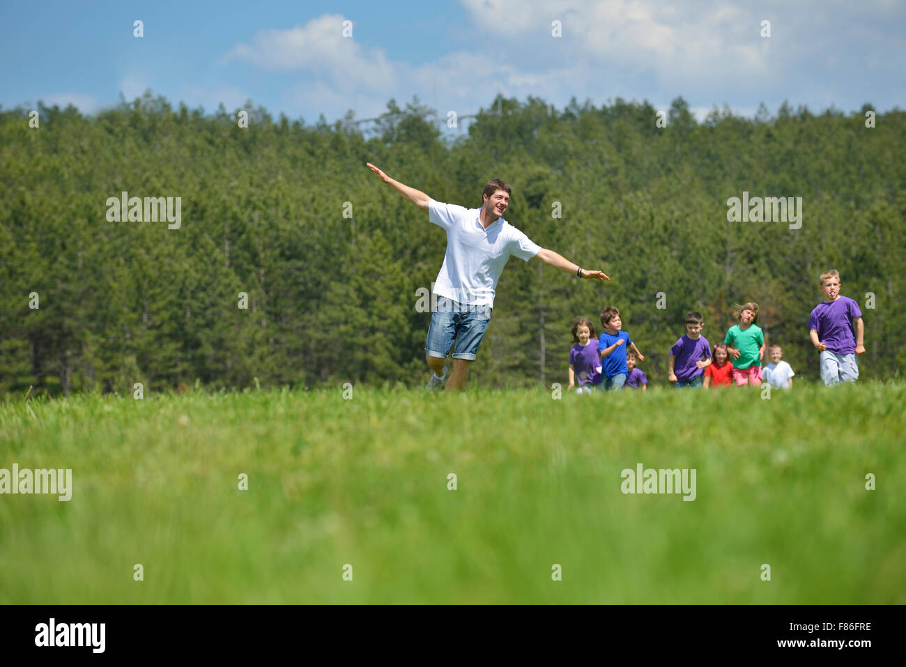 happy kids group have fun in nature outdoors park Stock Photo - Alamy