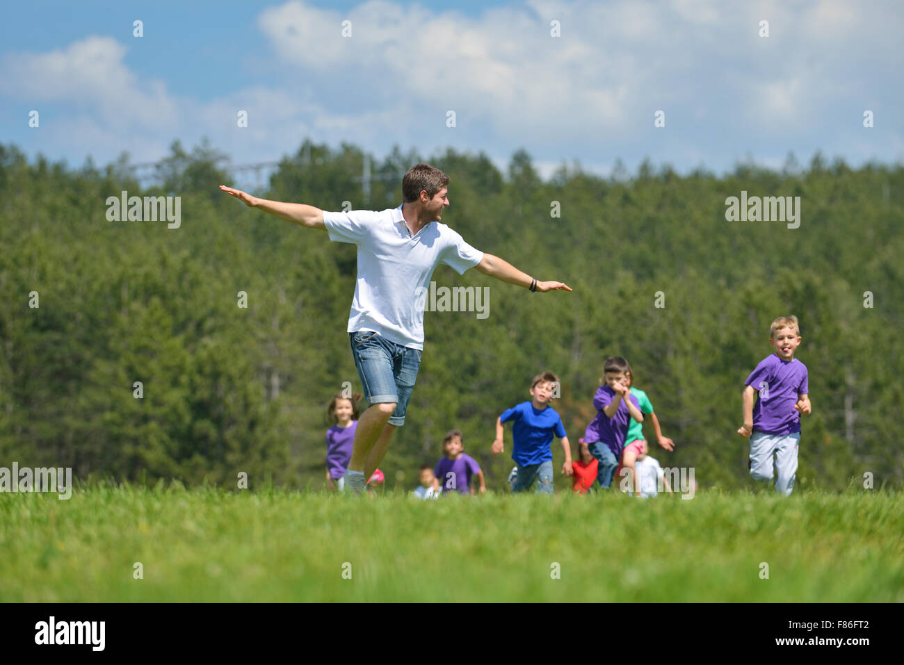 happy kids group have fun in nature outdoors park Stock Photo - Alamy
