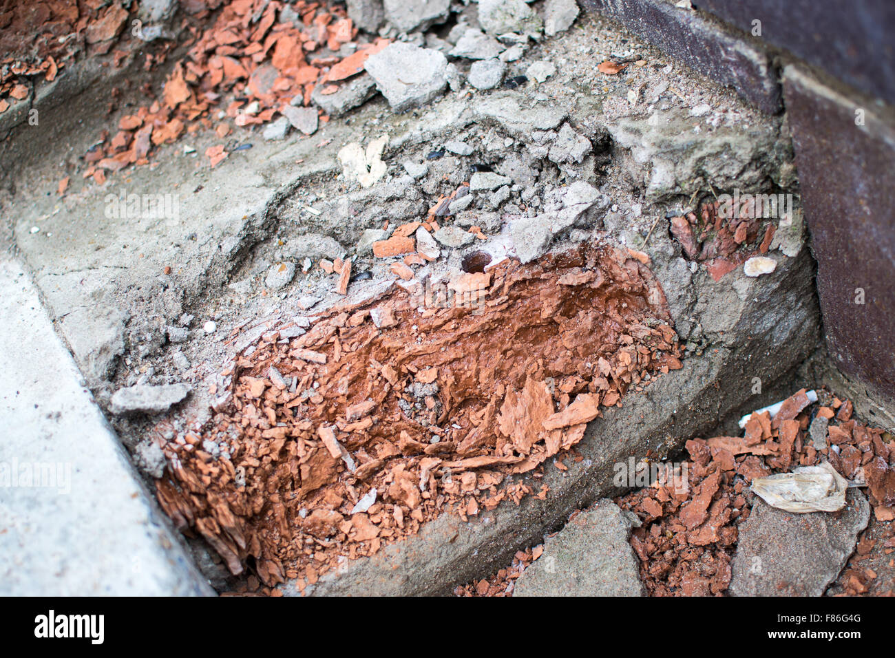 Crumbling red and grey bricks on a pedestrian staircase showing signs ...