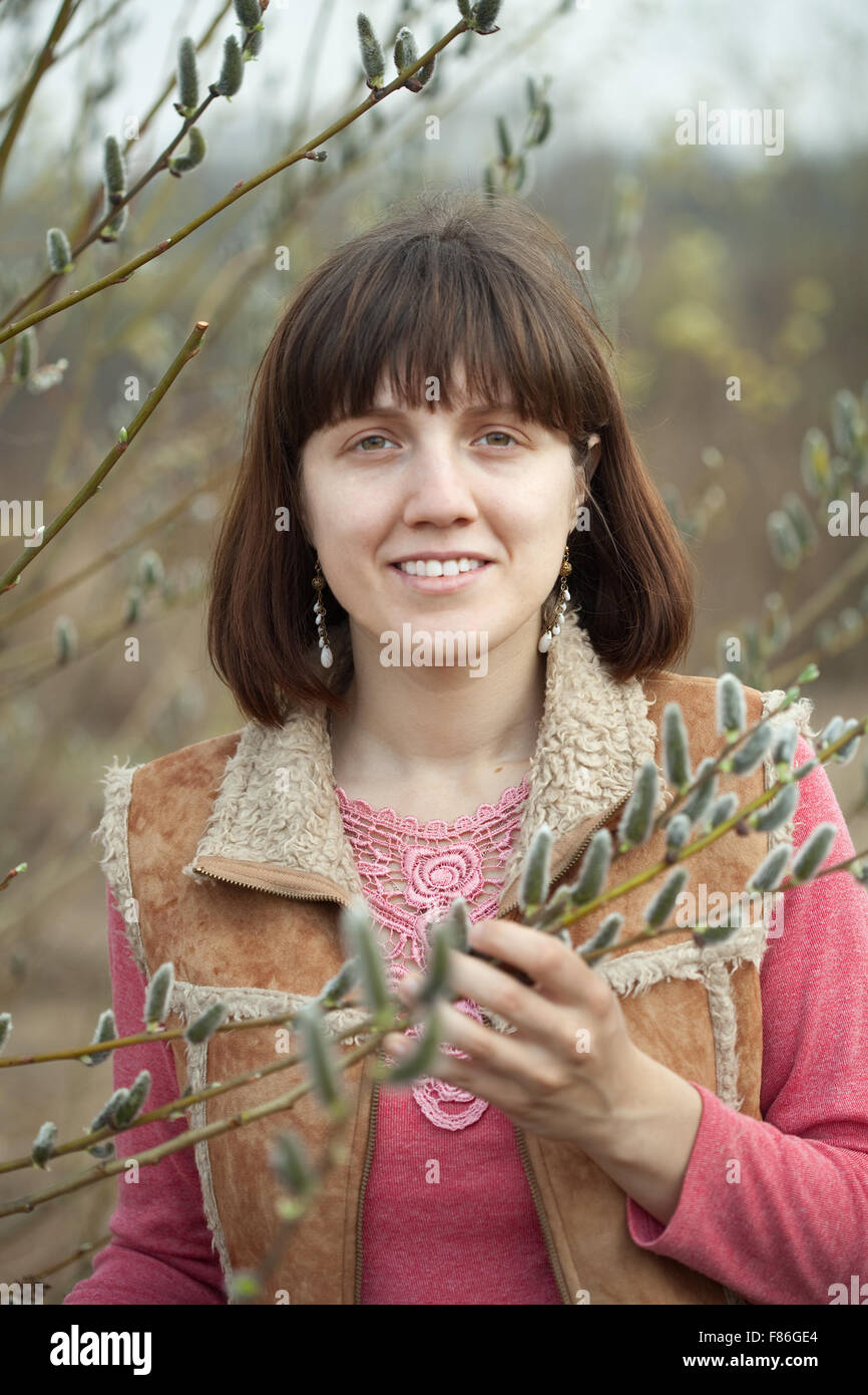 Smiling girl in spring willow twig with buds outdoor Stock Photo - Alamy