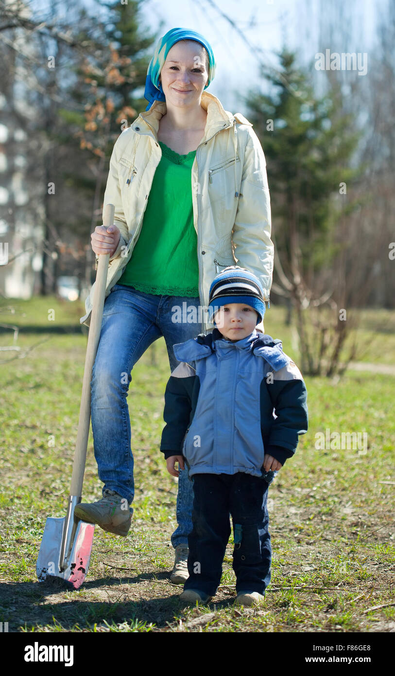 young woman and boy working with spade in garden Stock Photo - Alamy