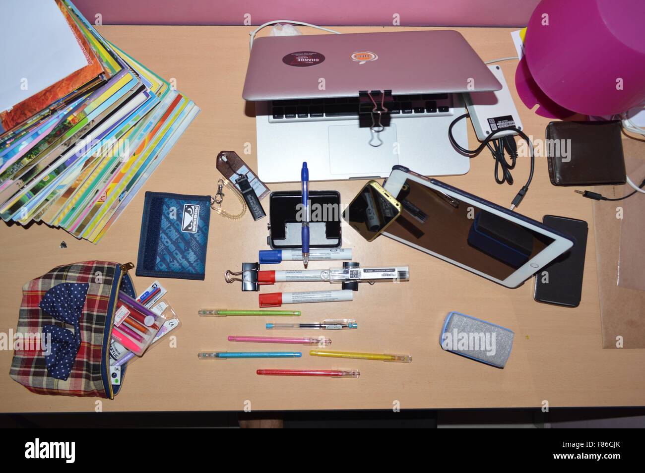 A messy study table of student with electronic devices and study stuffs ...