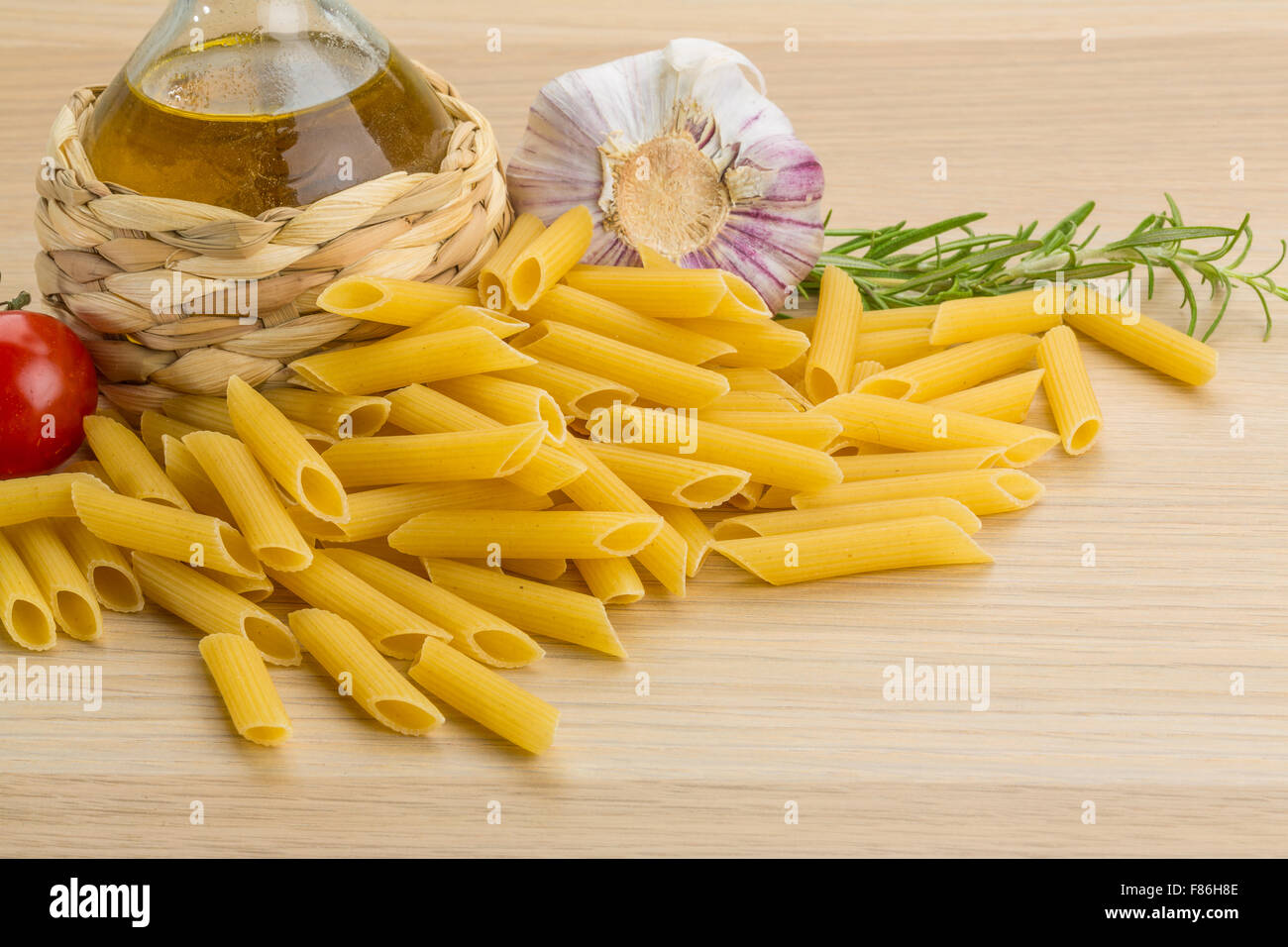 Penne - raw italian pasta with oil Stock Photo - Alamy