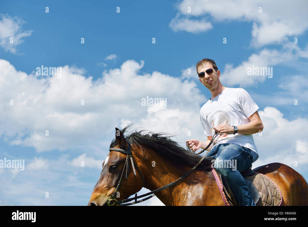 young man ride horse farm animal with blue sky in background Stock ...