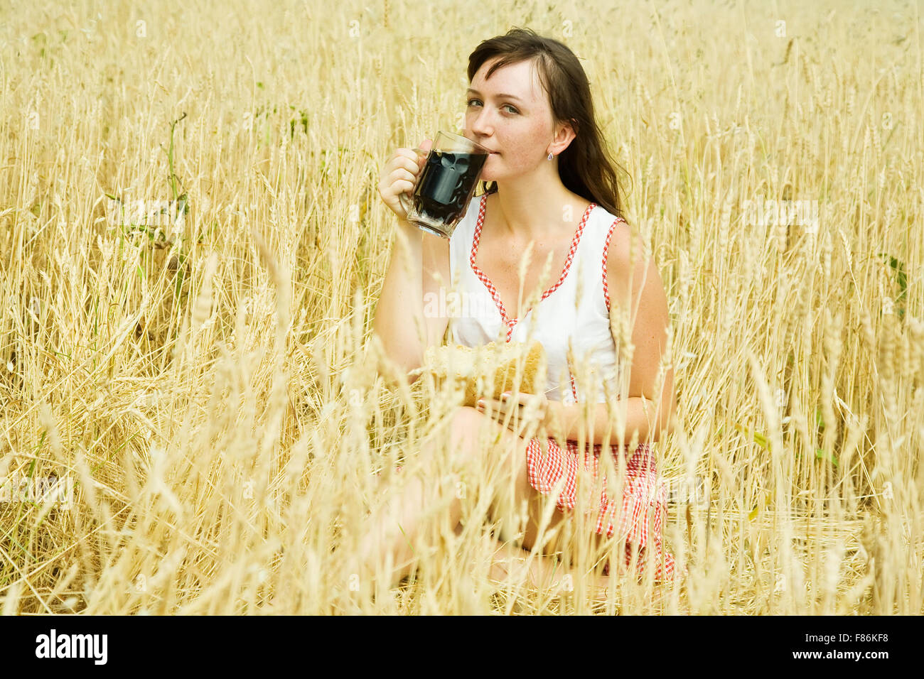 Girl with quass and bread at wheat field Stock Photo - Alamy
