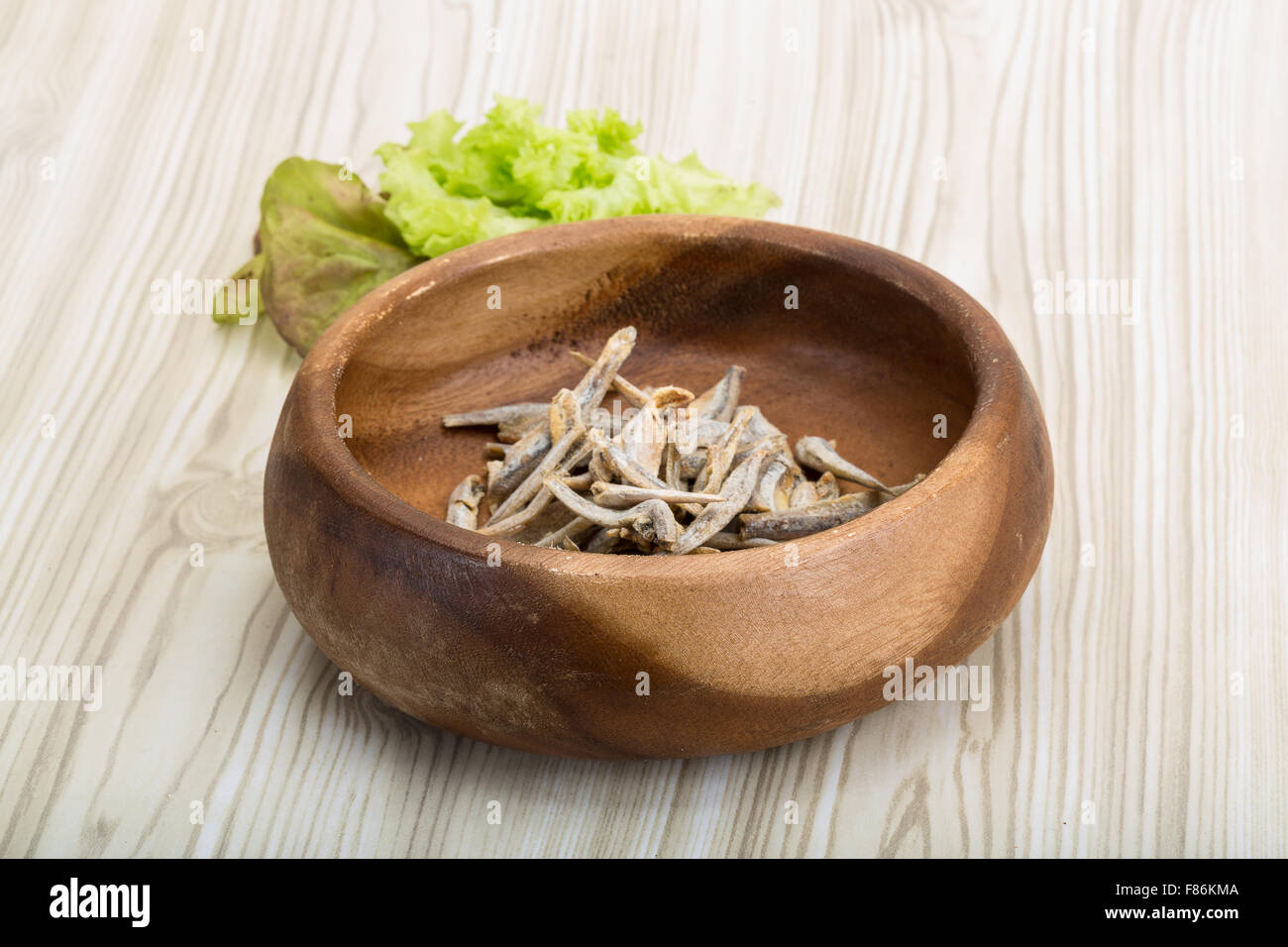 Dries anchovy - small fishes in the bowl Stock Photo - Alamy