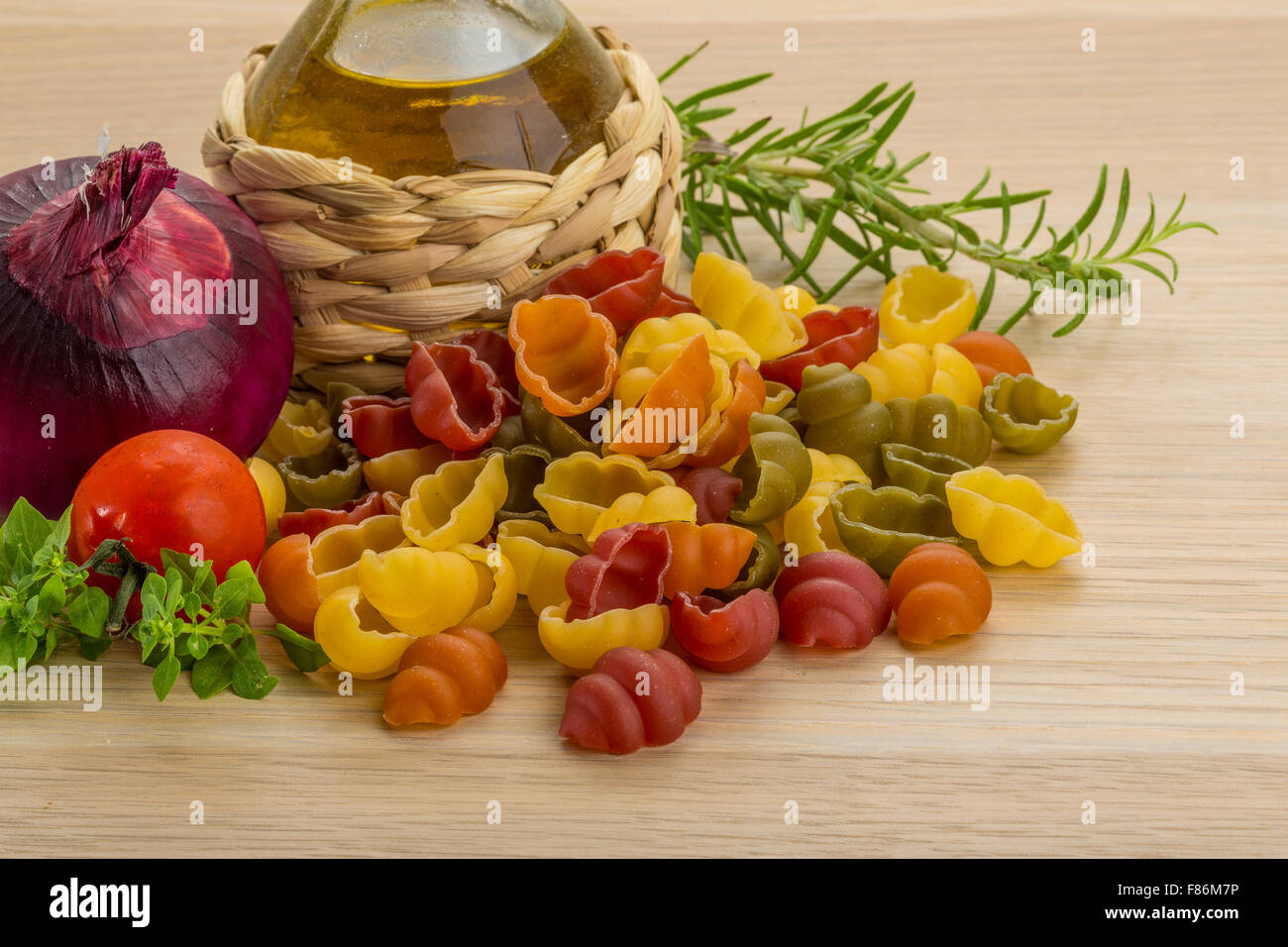 Raw macaroni - shell pasta with herbs Stock Photo - Alamy