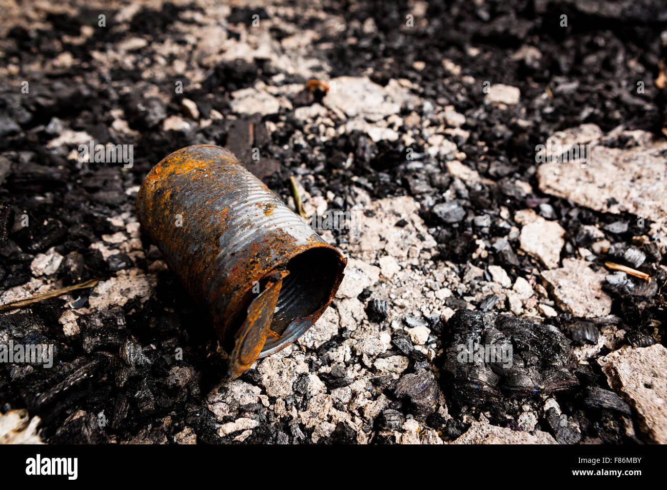 Tin can on burned ground Stock Photo - Alamy