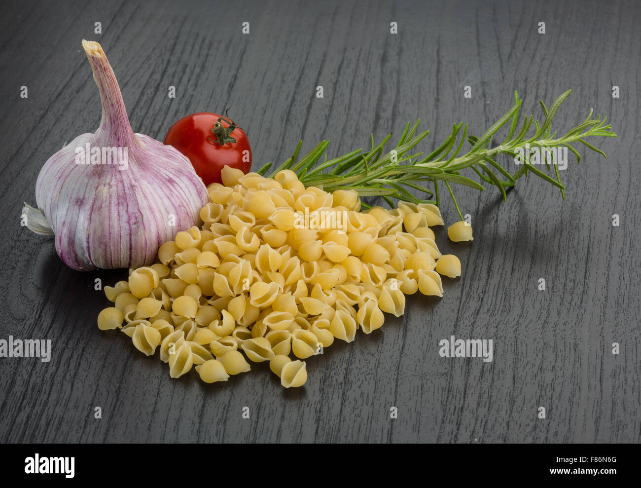 Raw shell pasta with herbs Stock Photo - Alamy