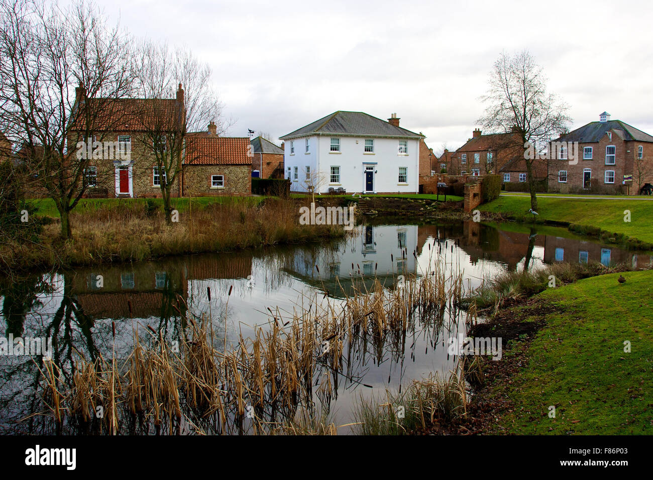 pond in yorkshire with reflection of buildings Stock Photo - Alamy